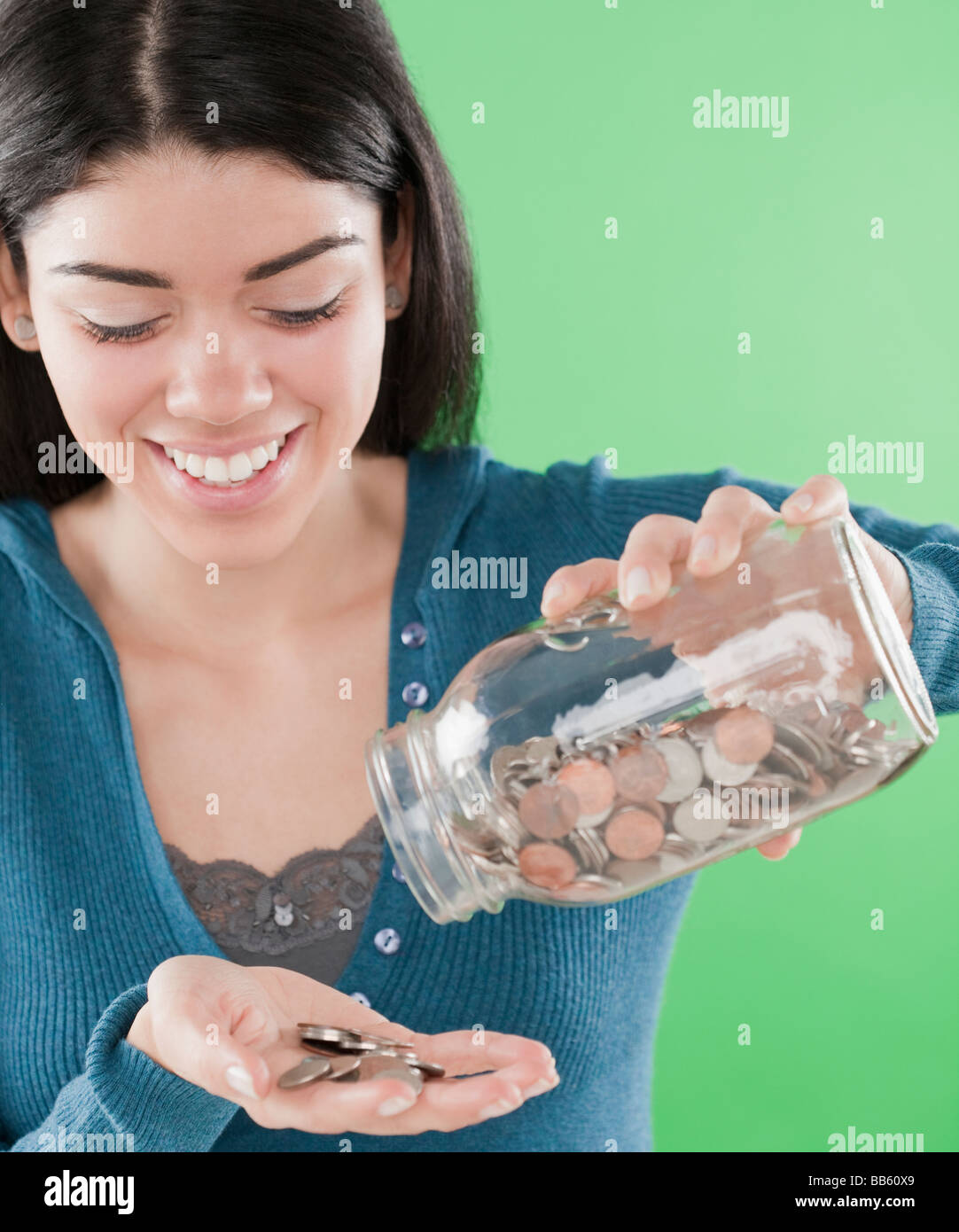 Pouring coin jar hi-res stock photography and images - Alamy