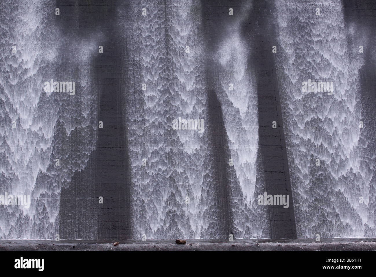 Water sliding down dam wall Stock Photo - Alamy