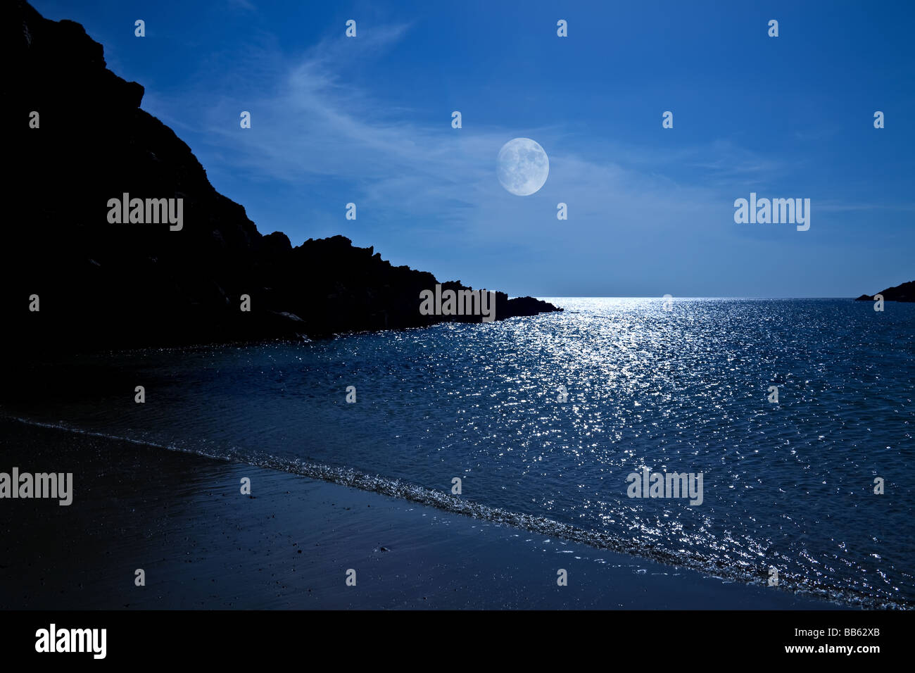 The rising moon reflected in the ocean from a beautiful bay Stock Photo ...