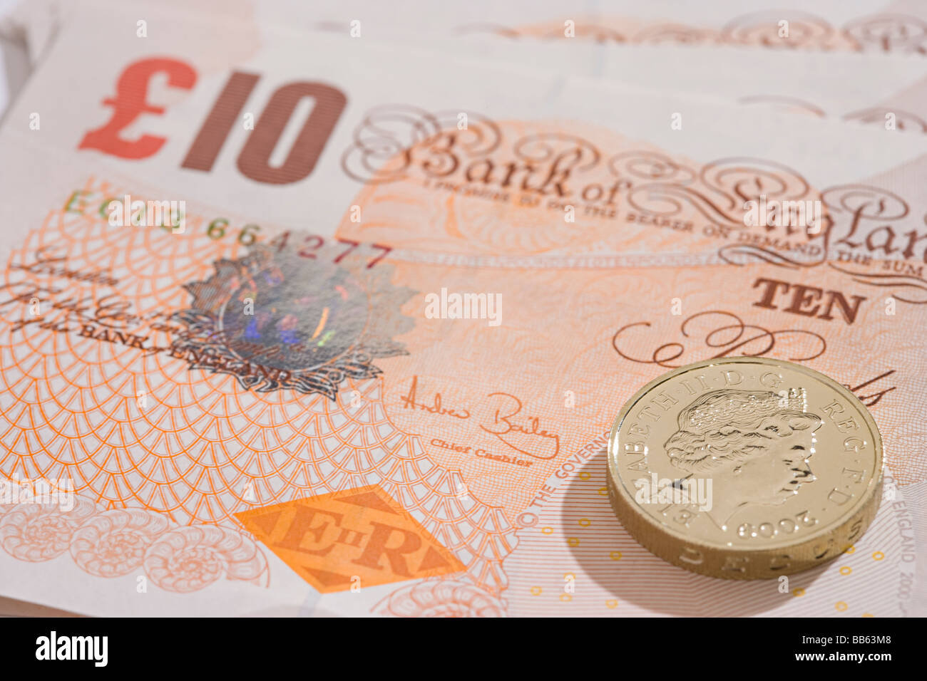 close up of a mint unused ten pound note with a pound coin Stock Photo ...