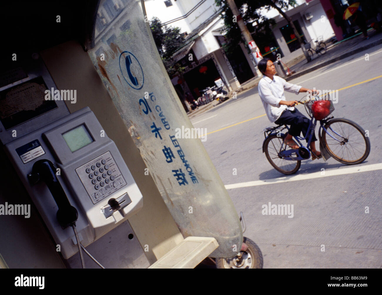 Payphone girl on bike china hi-res stock photography and images - Alamy