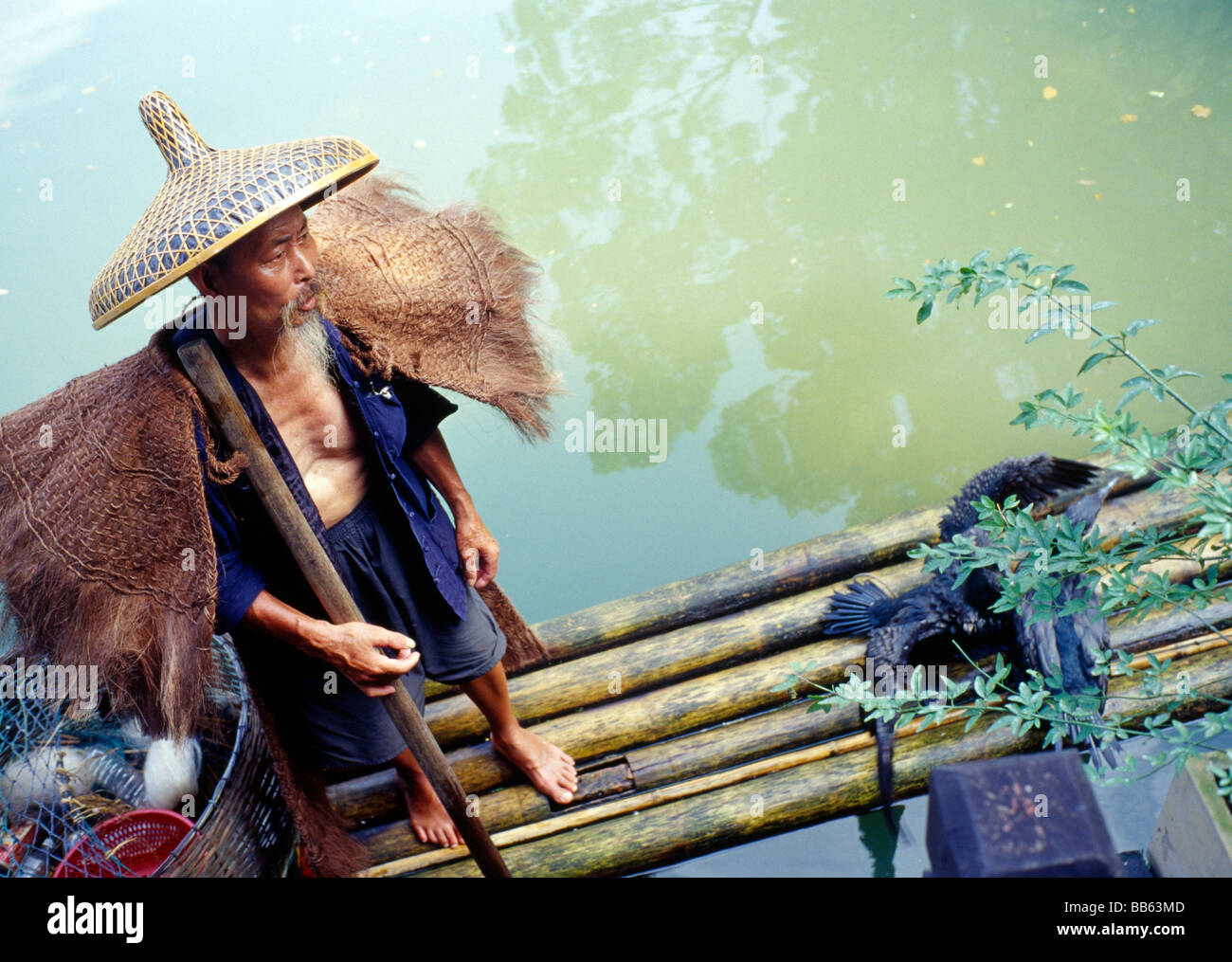 Chinese fisherman on raft Stock Photo - Alamy