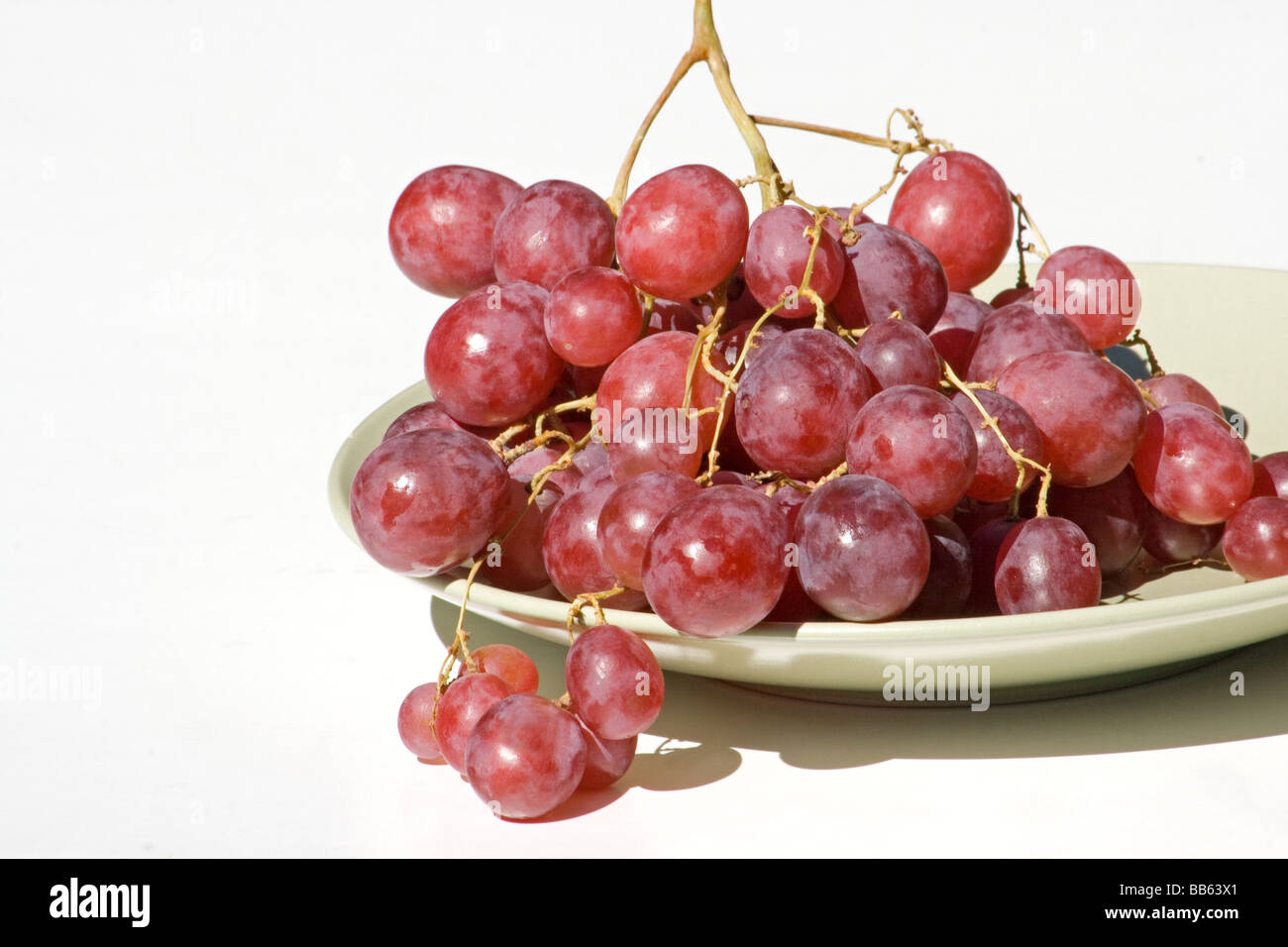 Cluster of red grapes on white bacground Stock Photo - Alamy