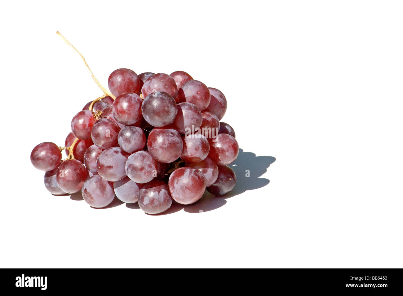 Red grapes on white background Stock Photo - Alamy