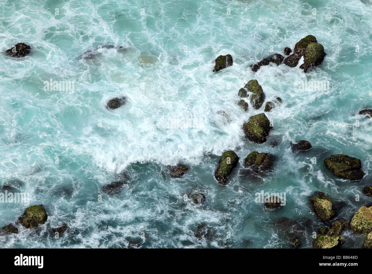 Ocean waves breaking on rocks for use as a background Stock Photo - Alamy