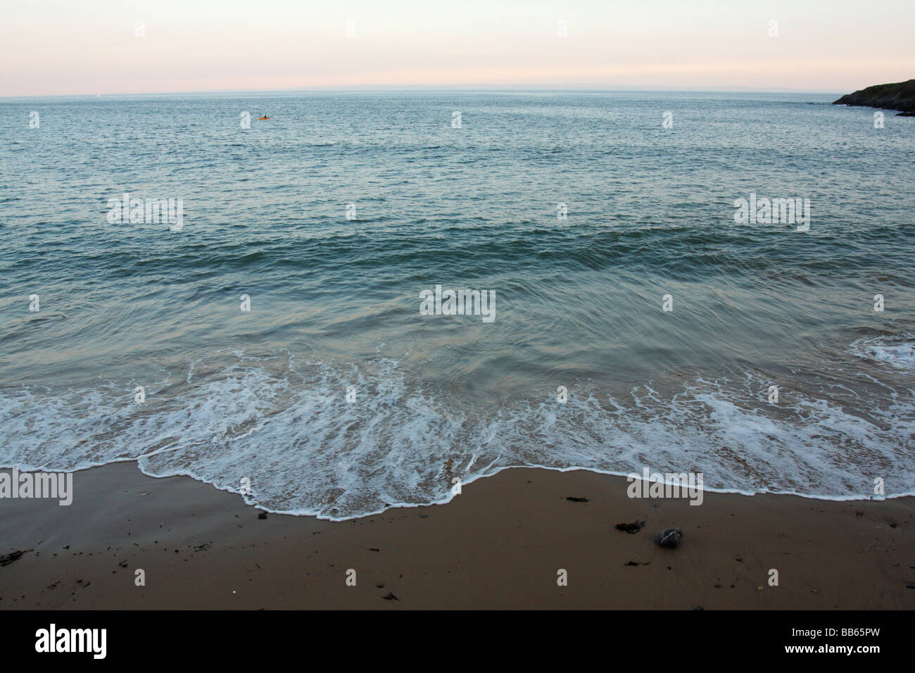 Wave washing up on to a beach Stock Photo - Alamy