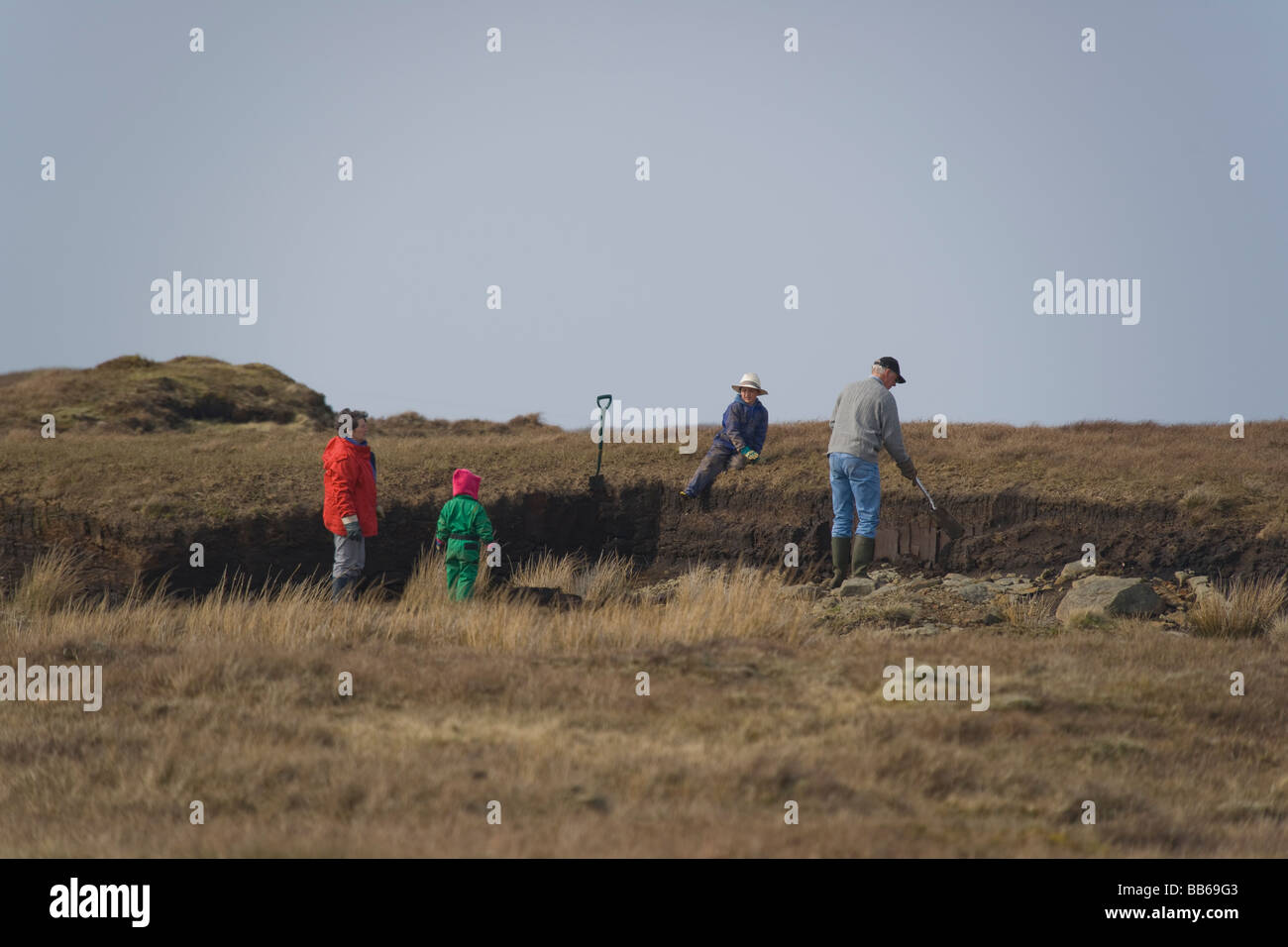 Family digging peat for fuel by the public roadside Dunvegan Isle of ...