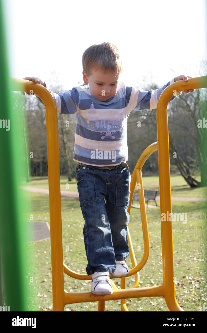 two year old boy playing by himself in a play park Stock Photo - Alamy