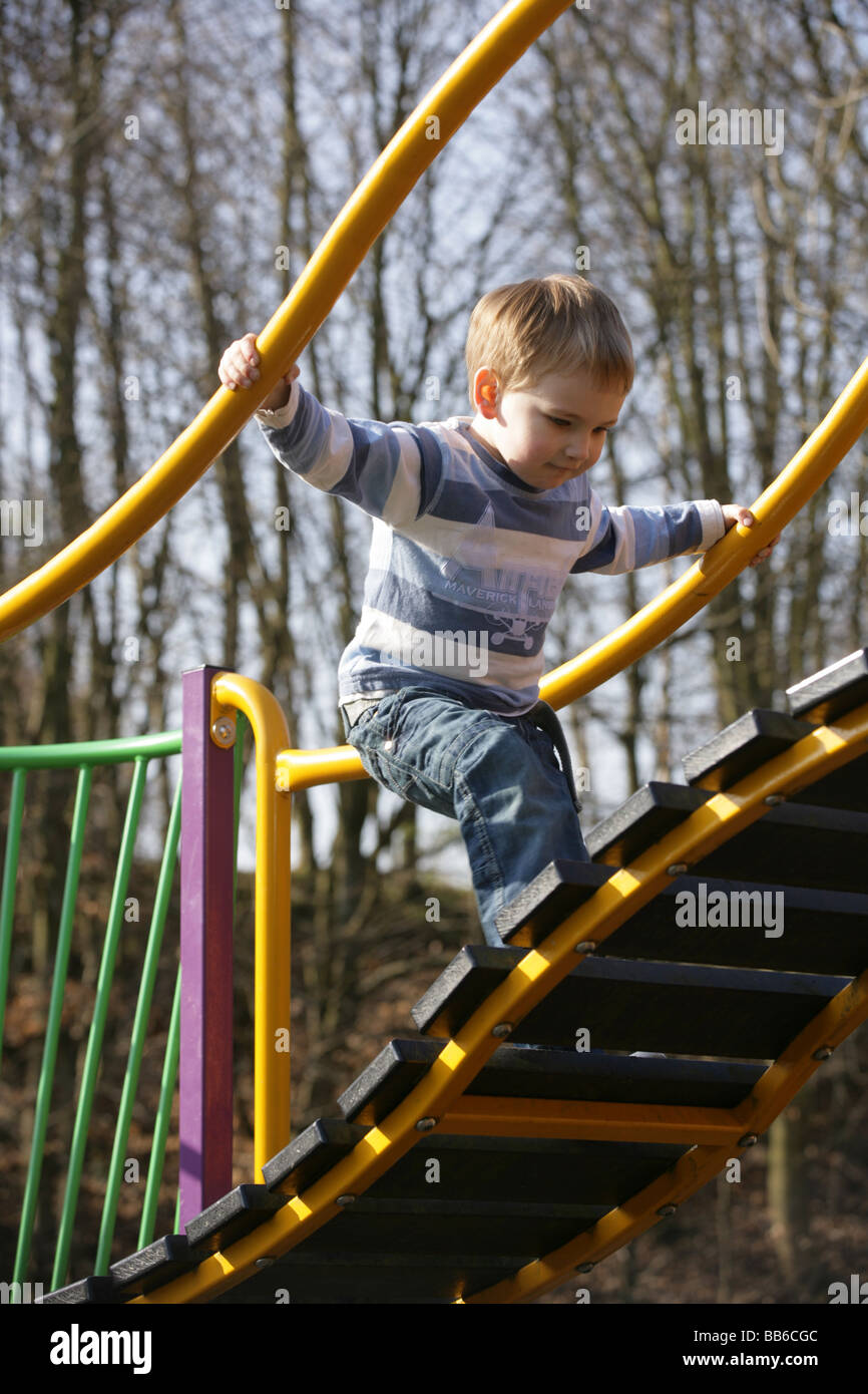 two year old boy playing by himself in a play park Stock Photo - Alamy