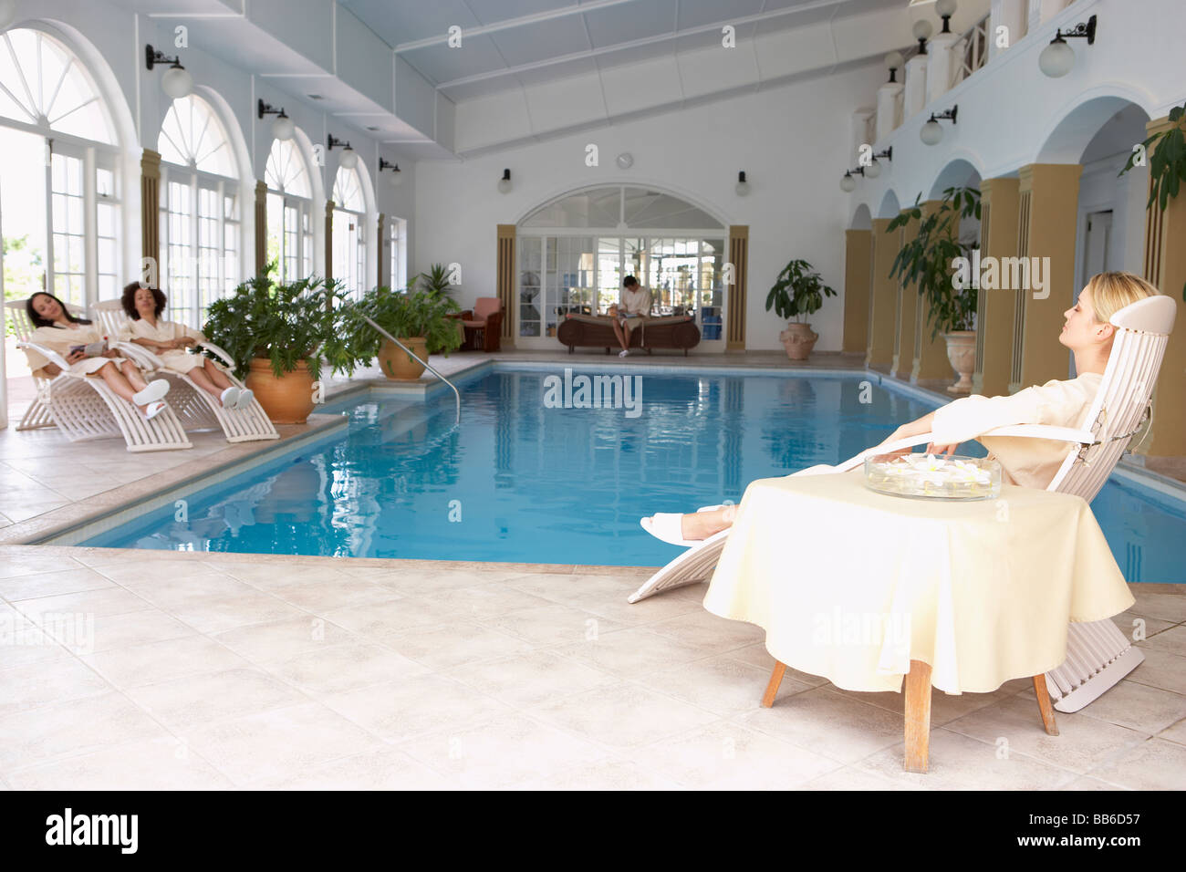 Women Relaxing Around Pool At Spa Stock Photo - Alamy