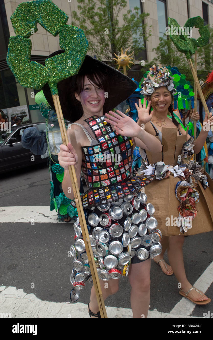Participants dressed in recycling costumes march in the Earth ...