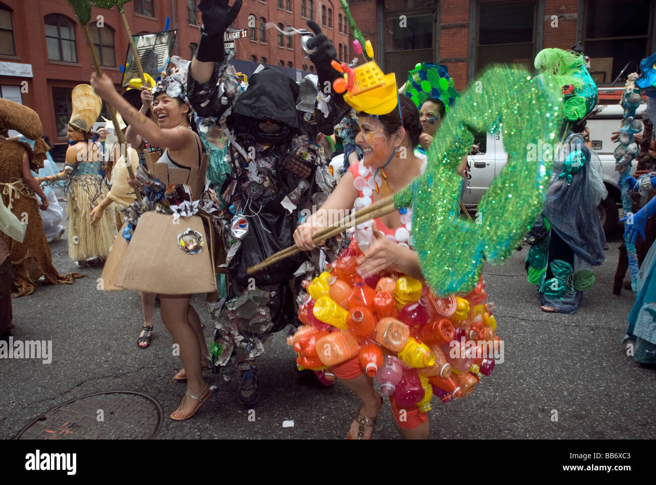 Recyclers battle trash in a piece of street theater during the Earth ...