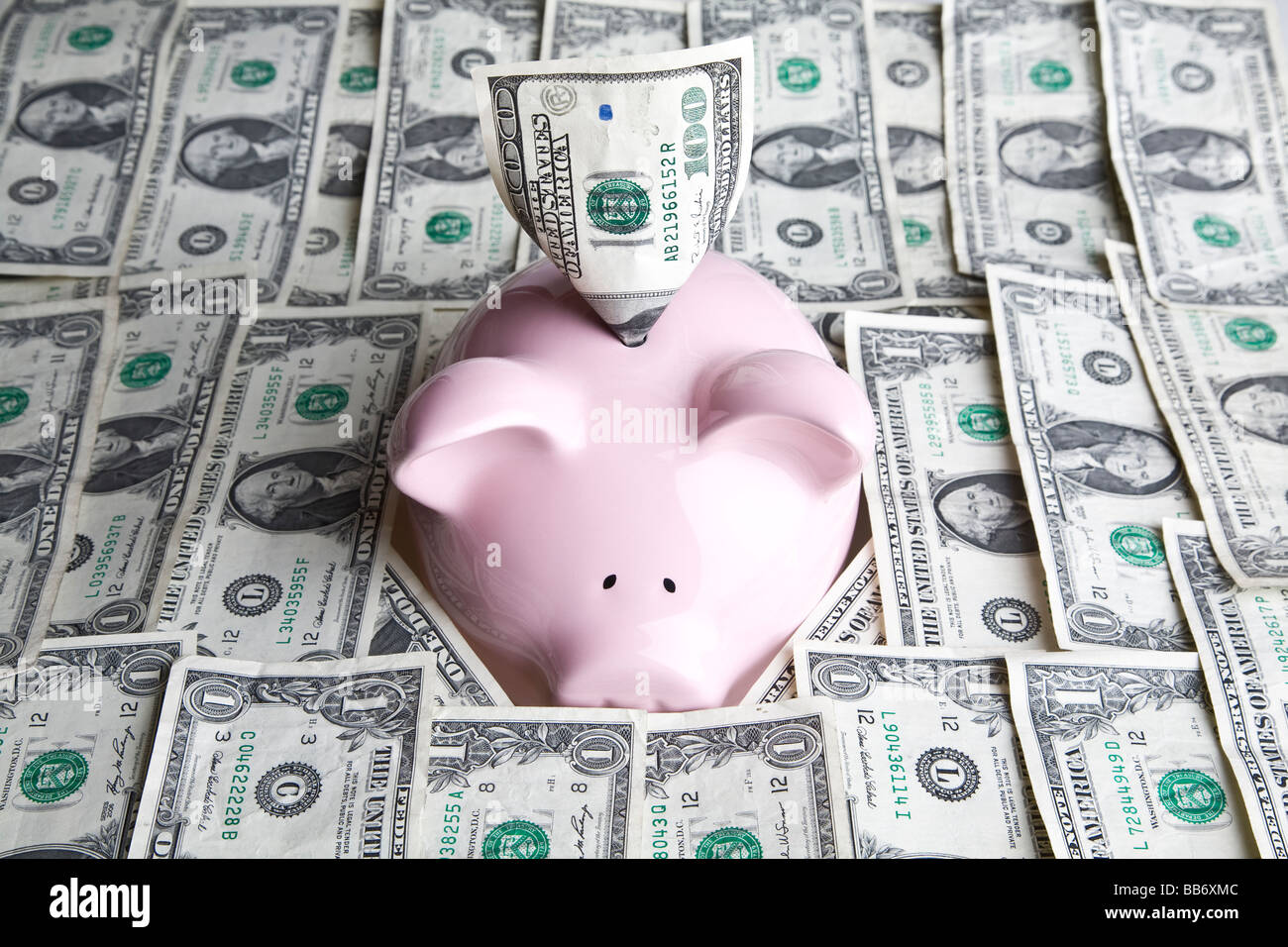 Dollar bills and piggy bank Stock Photo - Alamy