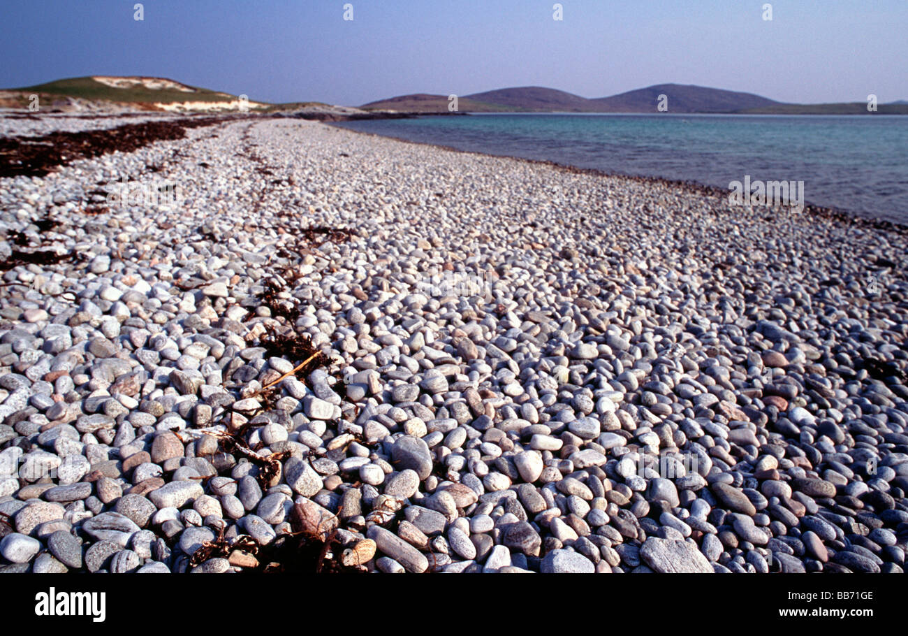 Walking along deserted pebble beach Isle of Berneray Scotland Stock ...