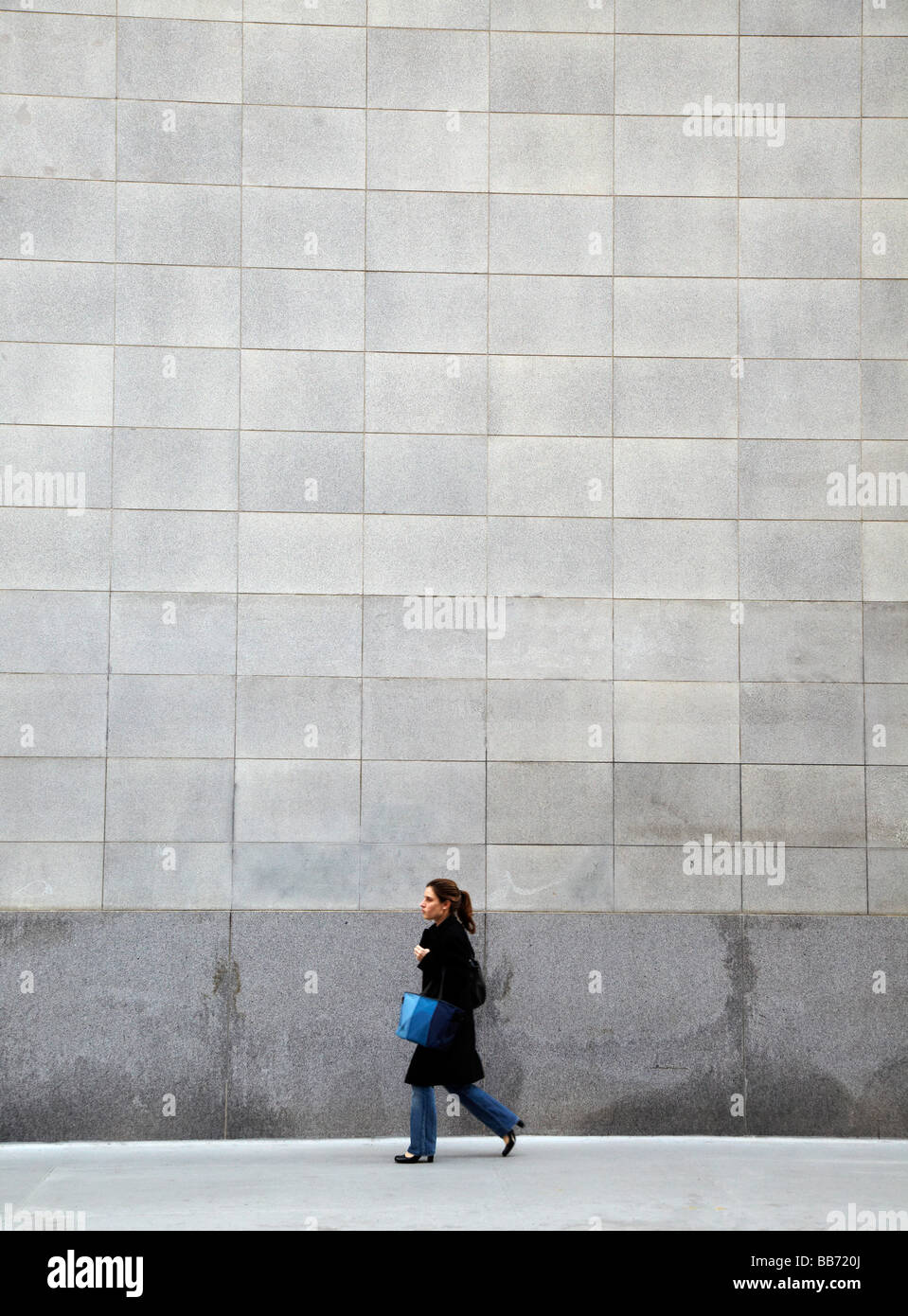 woman walking with stone wall Stock Photo - Alamy