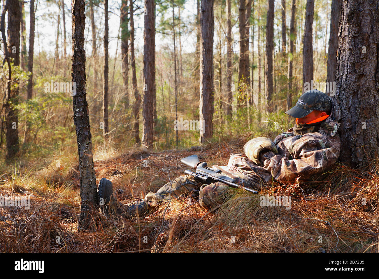 HUNTER TAKING A NAP AGAINST A PINE TREE TRACKING WILD BOAR REMINGTON ...
