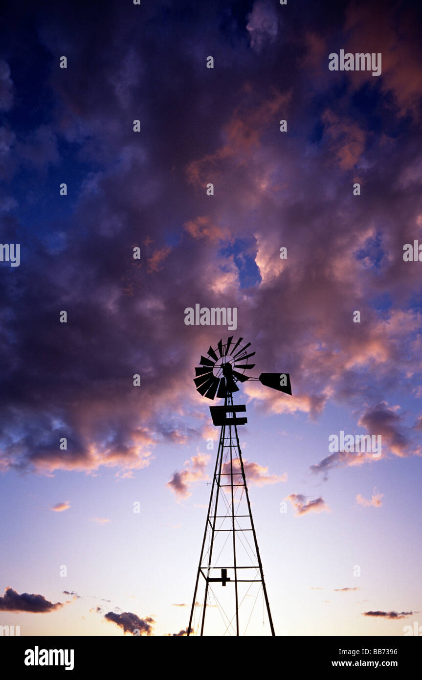 Windmill pump at sunset Stock Photo - Alamy