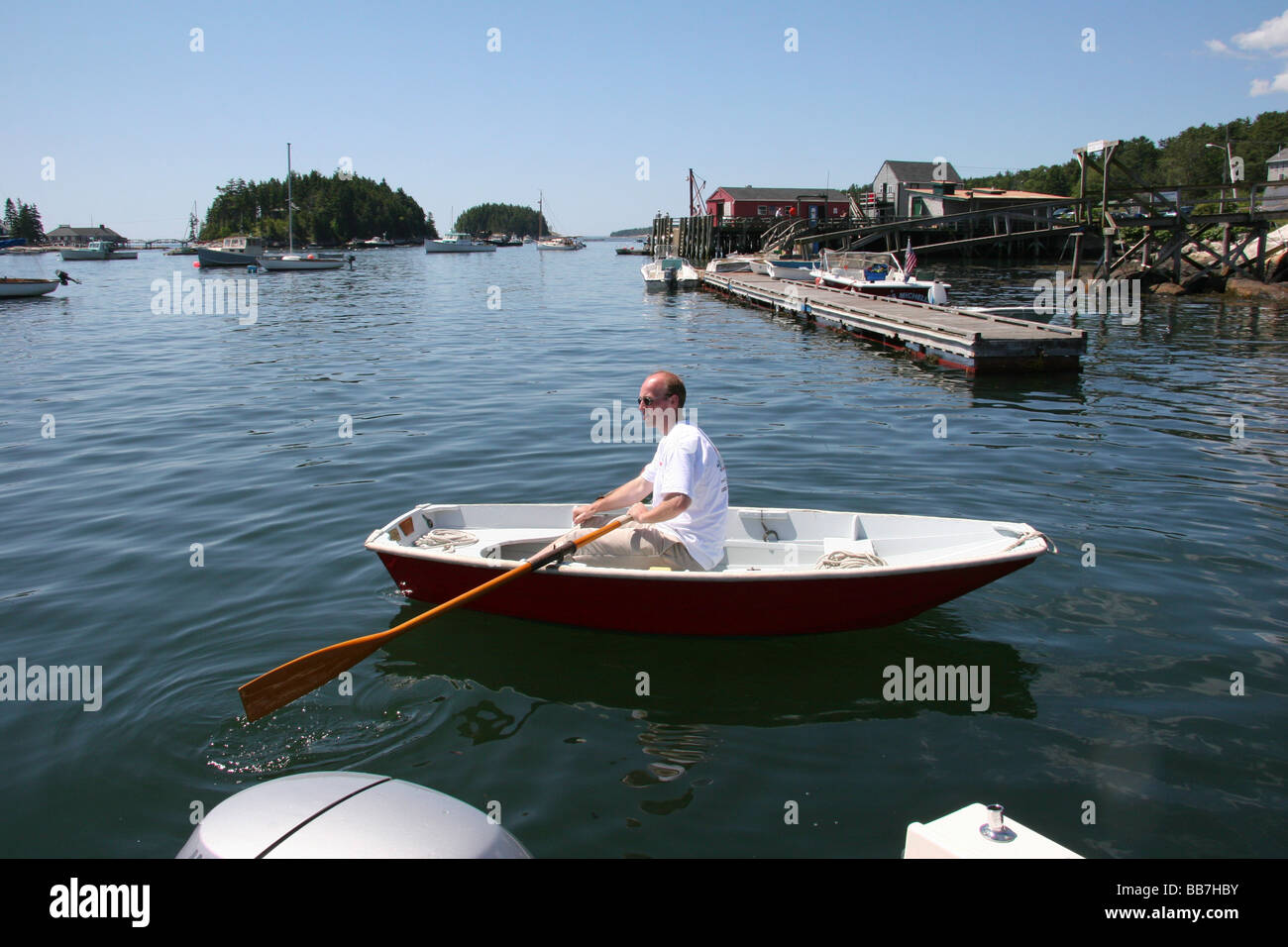 Rowing a Red Tender Stock Photo - Alamy