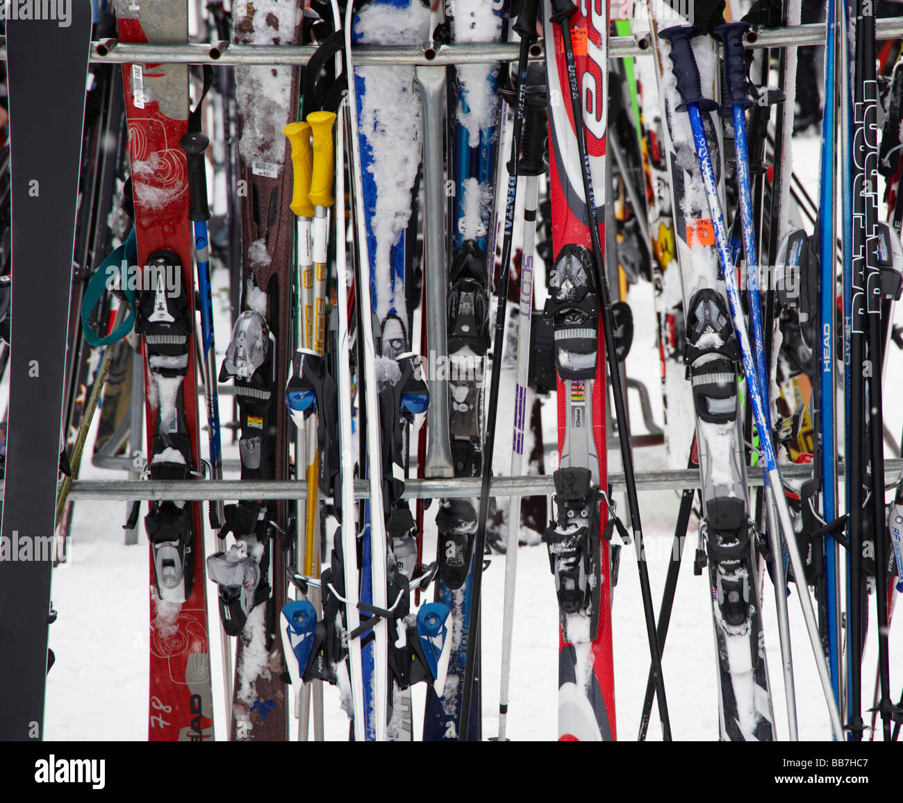 Skis and poles leaning against ski rack, close-up Stock Photo - Alamy