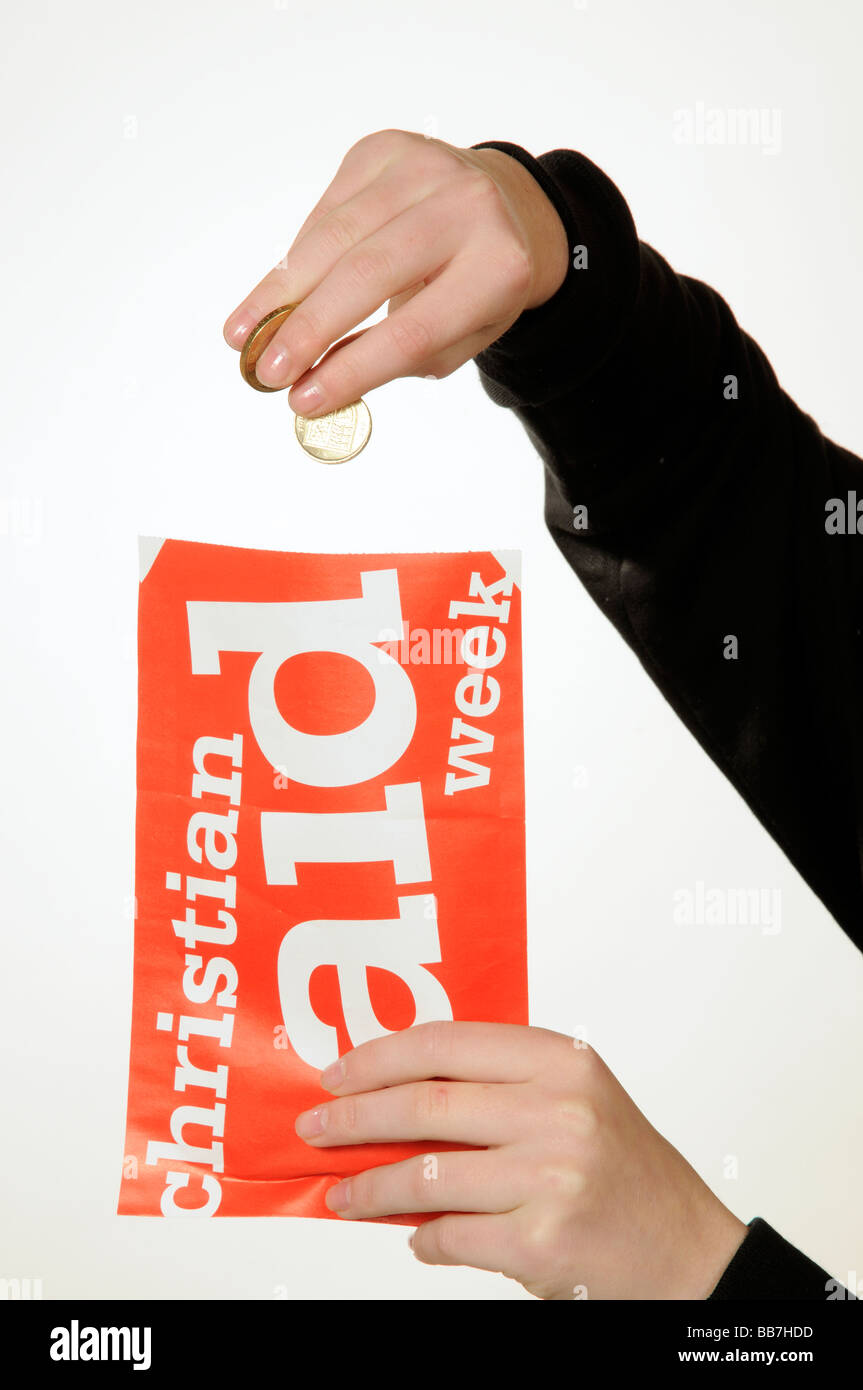 Charitable donation cash being put into Christian Aid envelope Stock ...