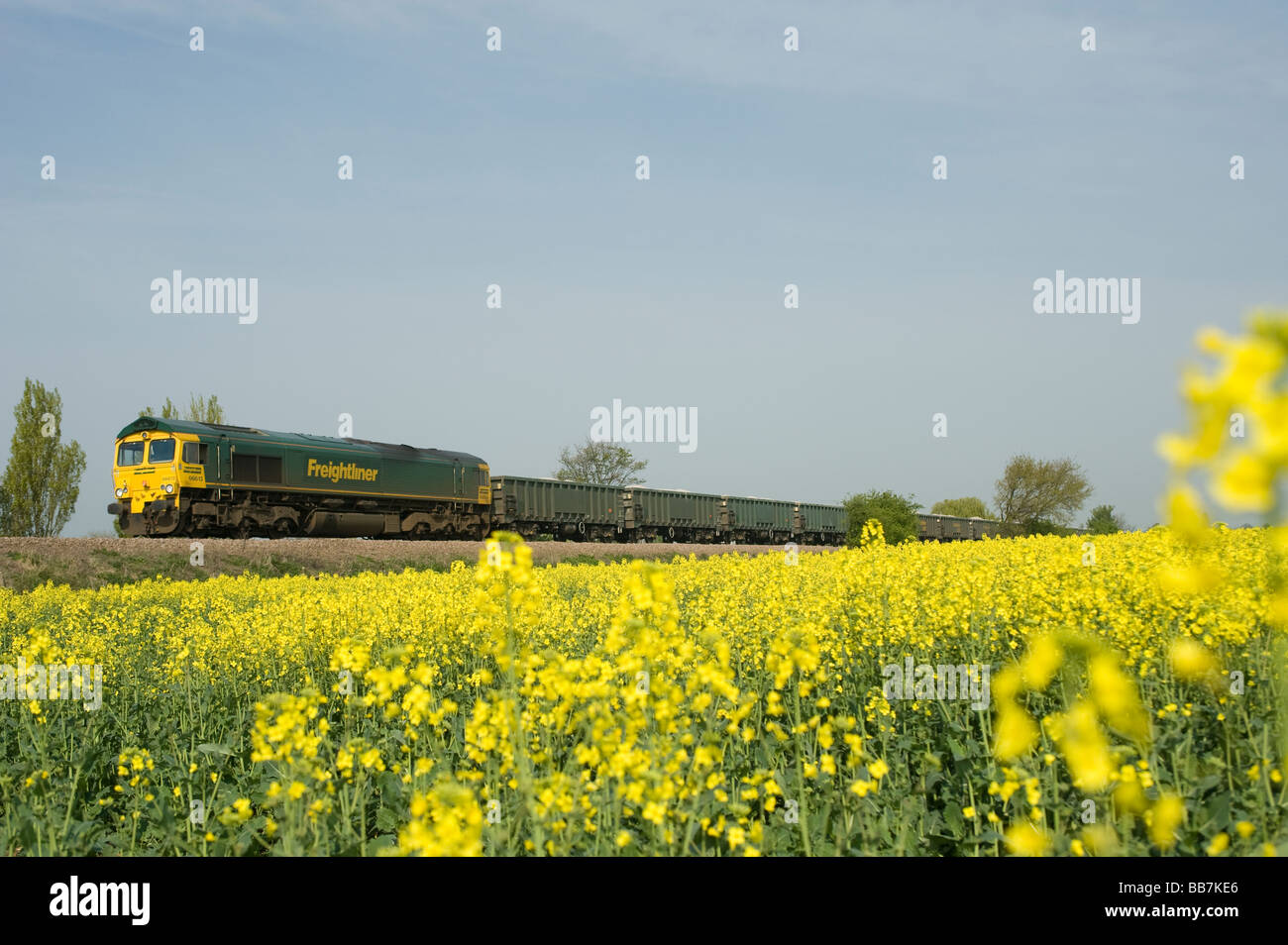 Class 66 diesel locomotive hauling a freight train of aggregate wagons ...
