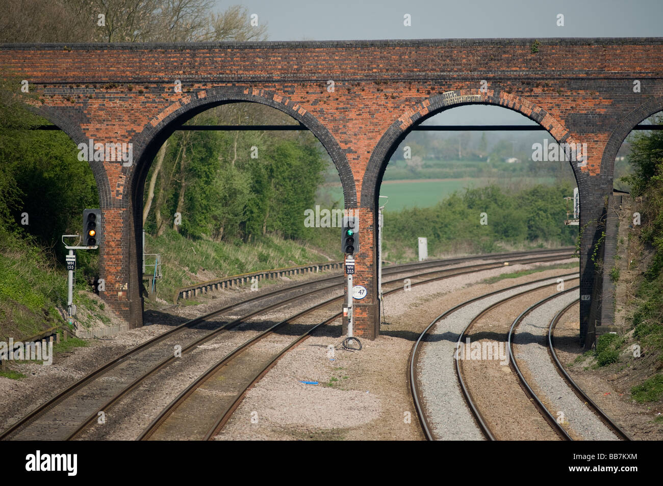 Empty railway track a green signal and a bridge in the English ...
