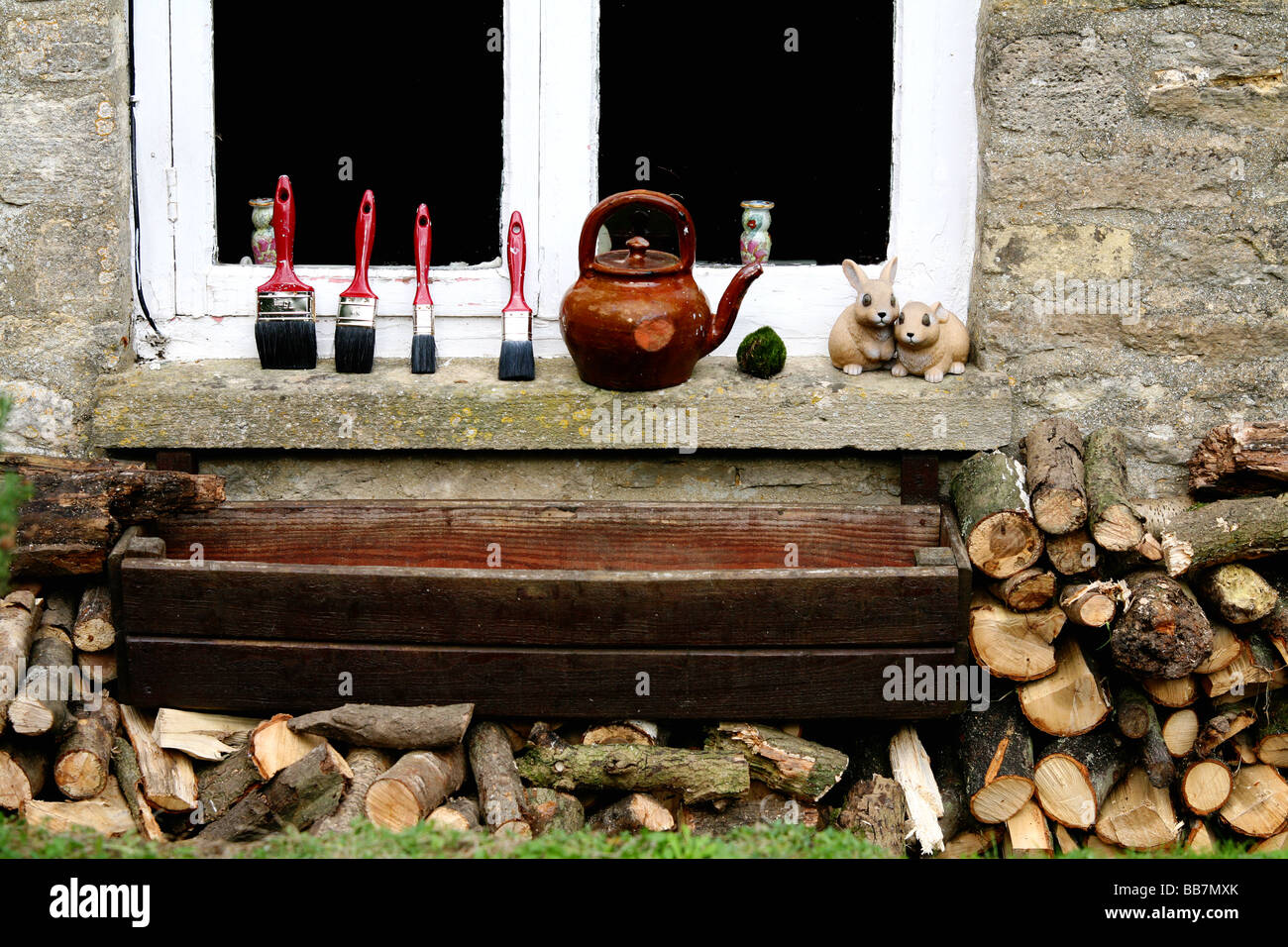 Cottage uk,Cotswold cottage,paint brushes,logs Stock Photo - Alamy