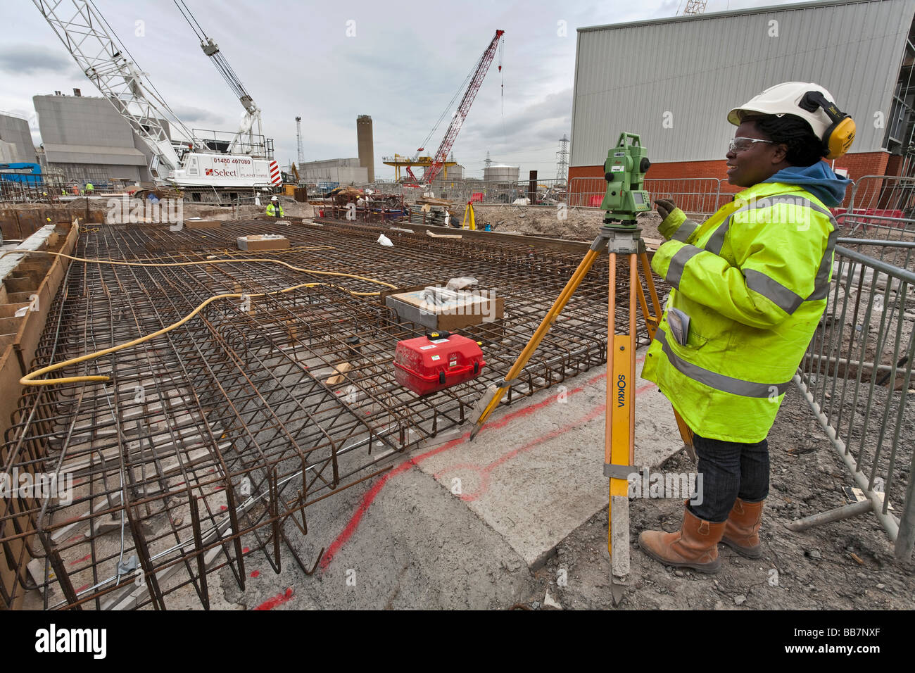 Surveyor working on a building site Stock Photo - Alamy