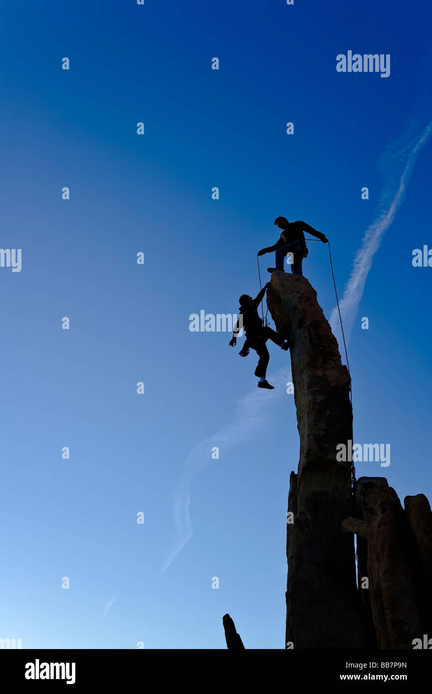 Team of climbers summitting a rock pinnacle Stock Photo - Alamy