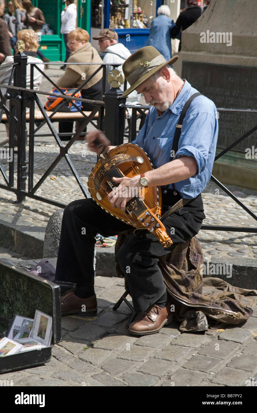 Street entertainer playing stringed instrument Stock Photo - Alamy