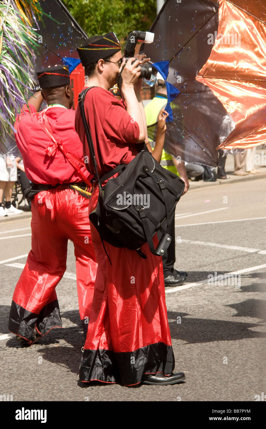 Caribbean carnival parade photographer in costume Stock Photo - Alamy
