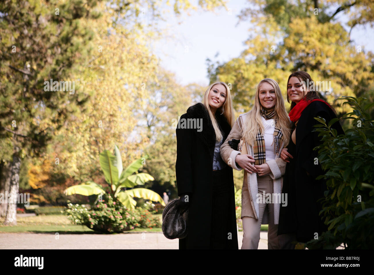three women waiting in a park Stock Photo - Alamy