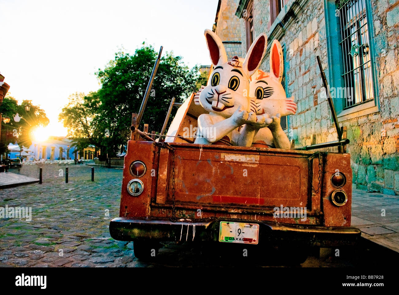 Old car with kitsh figurines of rabbits on the street; Mexico Stock ...