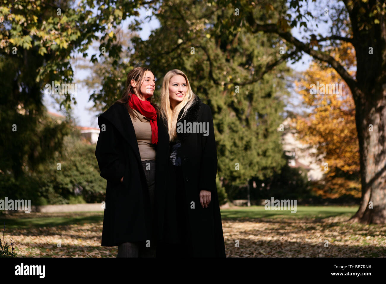 two women waiting in a park Stock Photo - Alamy