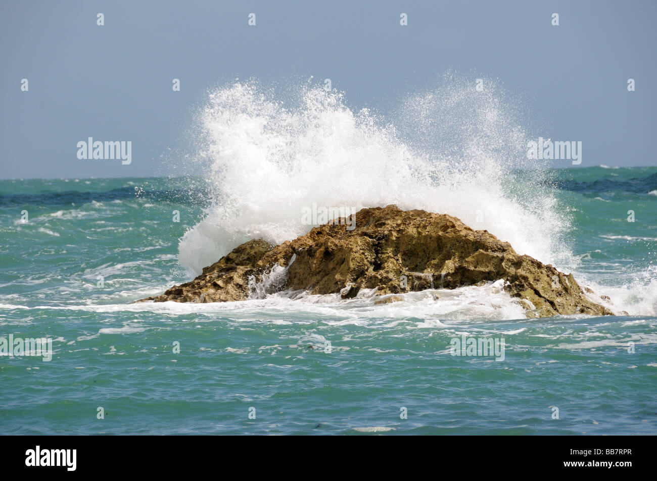 Wave breaking on rock Stock Photo - Alamy