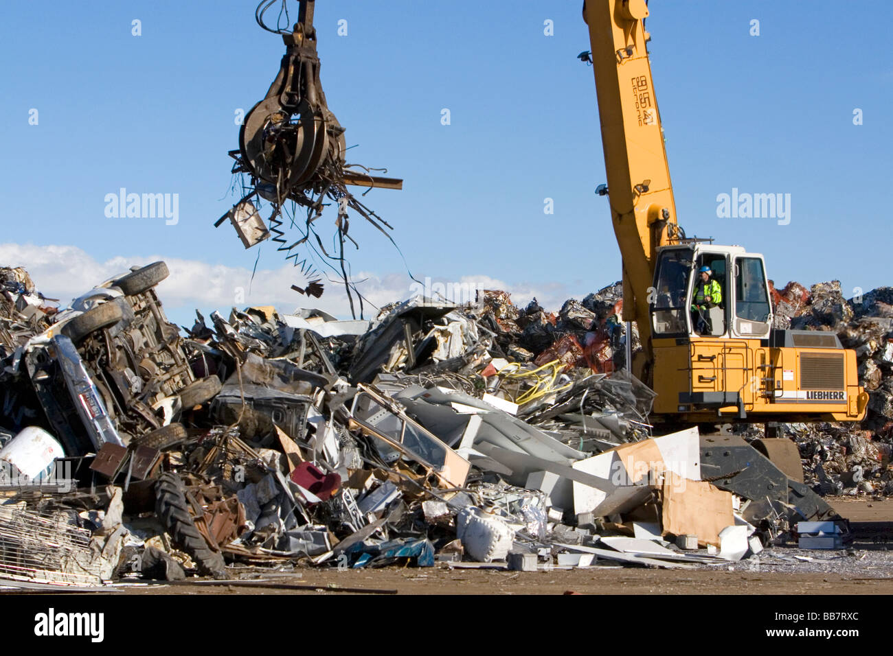 Hydraulic grapple lifting scrap steel for recycling at the Pacific ...