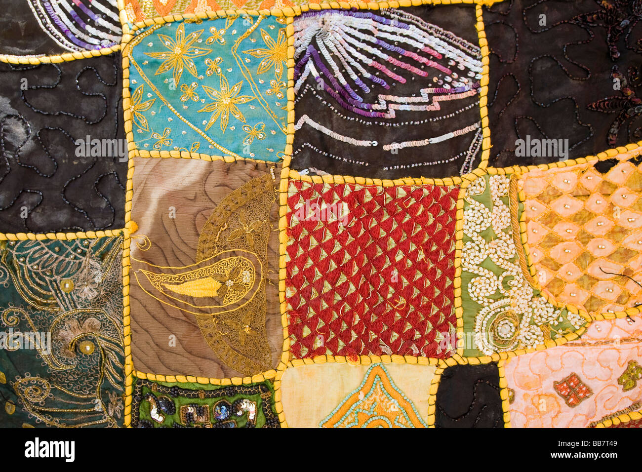 Hand sewn brightly coloured patchwork material on display in a bazaar ...