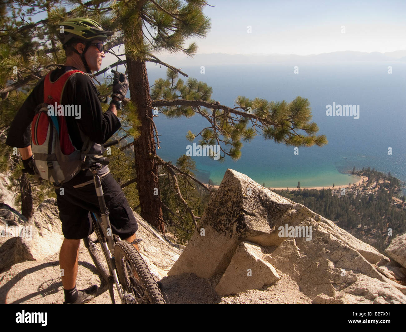 A mountain biker enjoys a view of Lake Tahoe from the Great Flume Trail ...