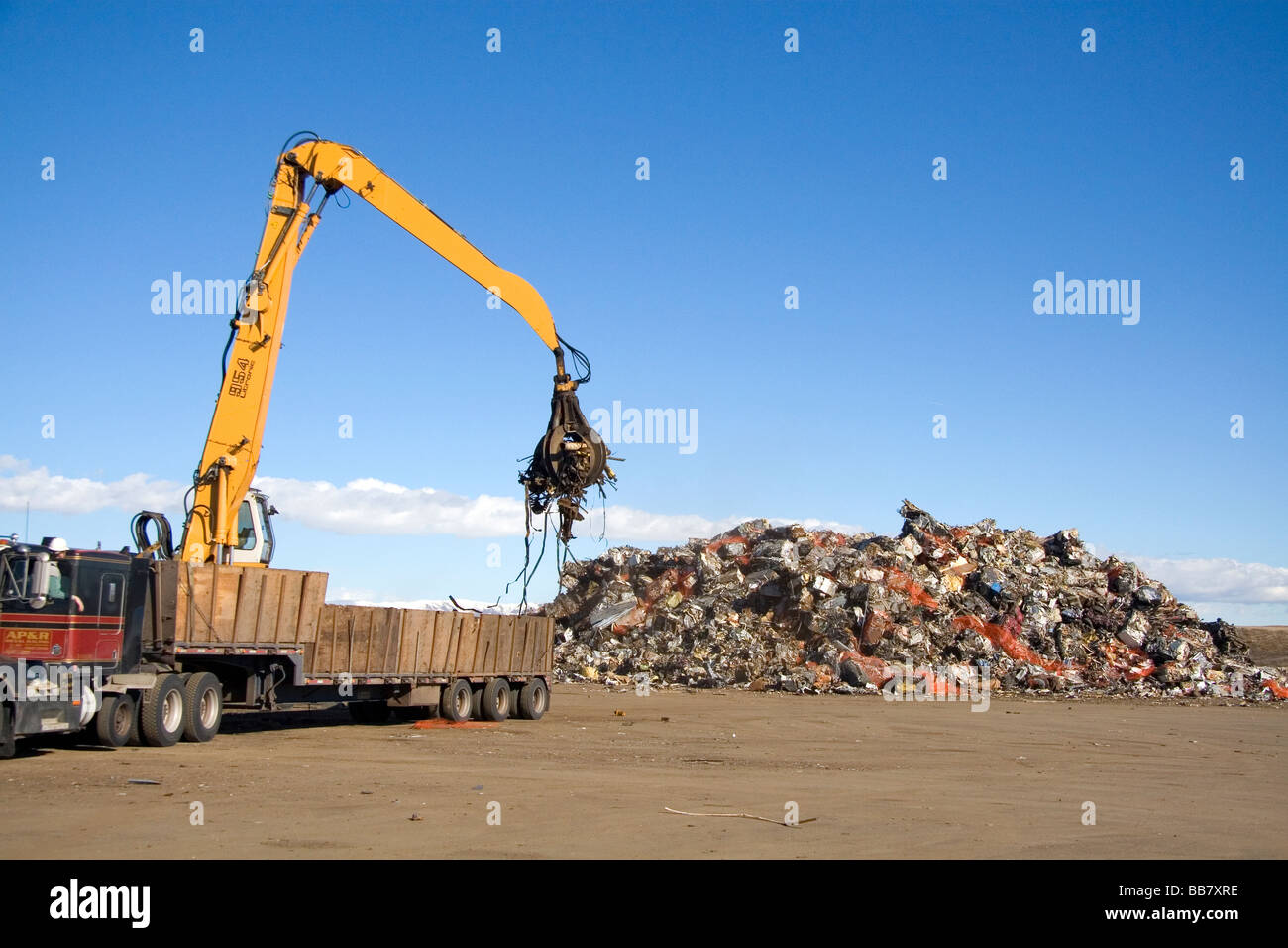 Hydraulic grapple lifting scrap steel for recycling at the Pacific ...