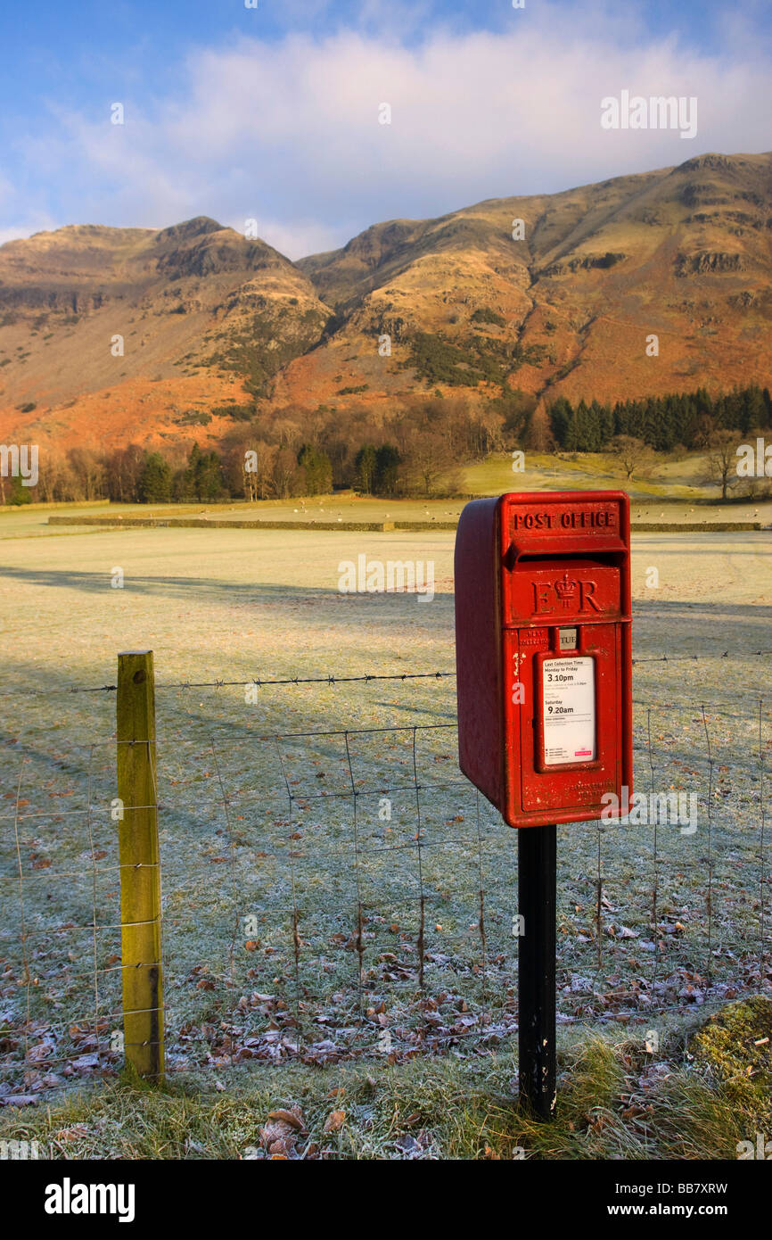 Red mailbox on roadside, fields in background; Cumbria, England, UK ...
