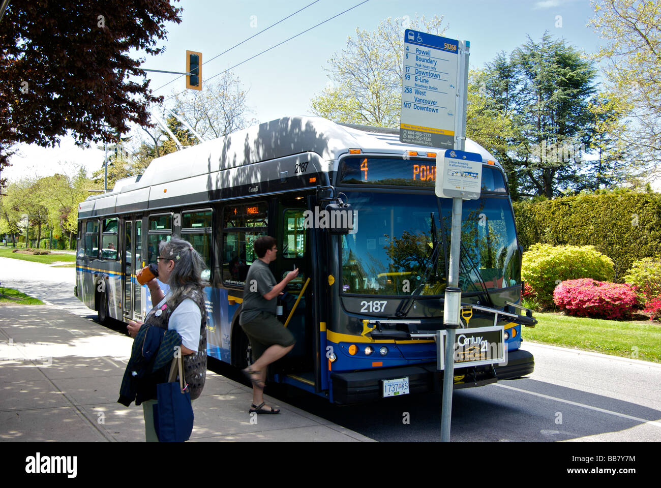 Passenger in slight motion blur boarding a Vancouver electric public ...