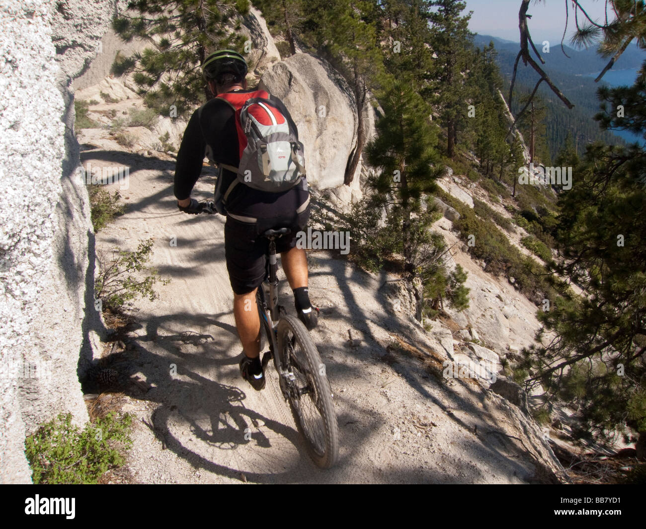 A mountain biker enjoys a view of Lake Tahoe from the Great Flume Trail ...