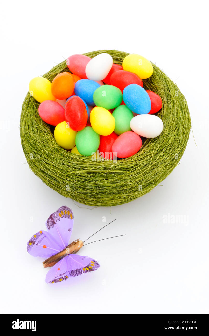 Candy easter eggs in an easter basket Stock Photo - Alamy