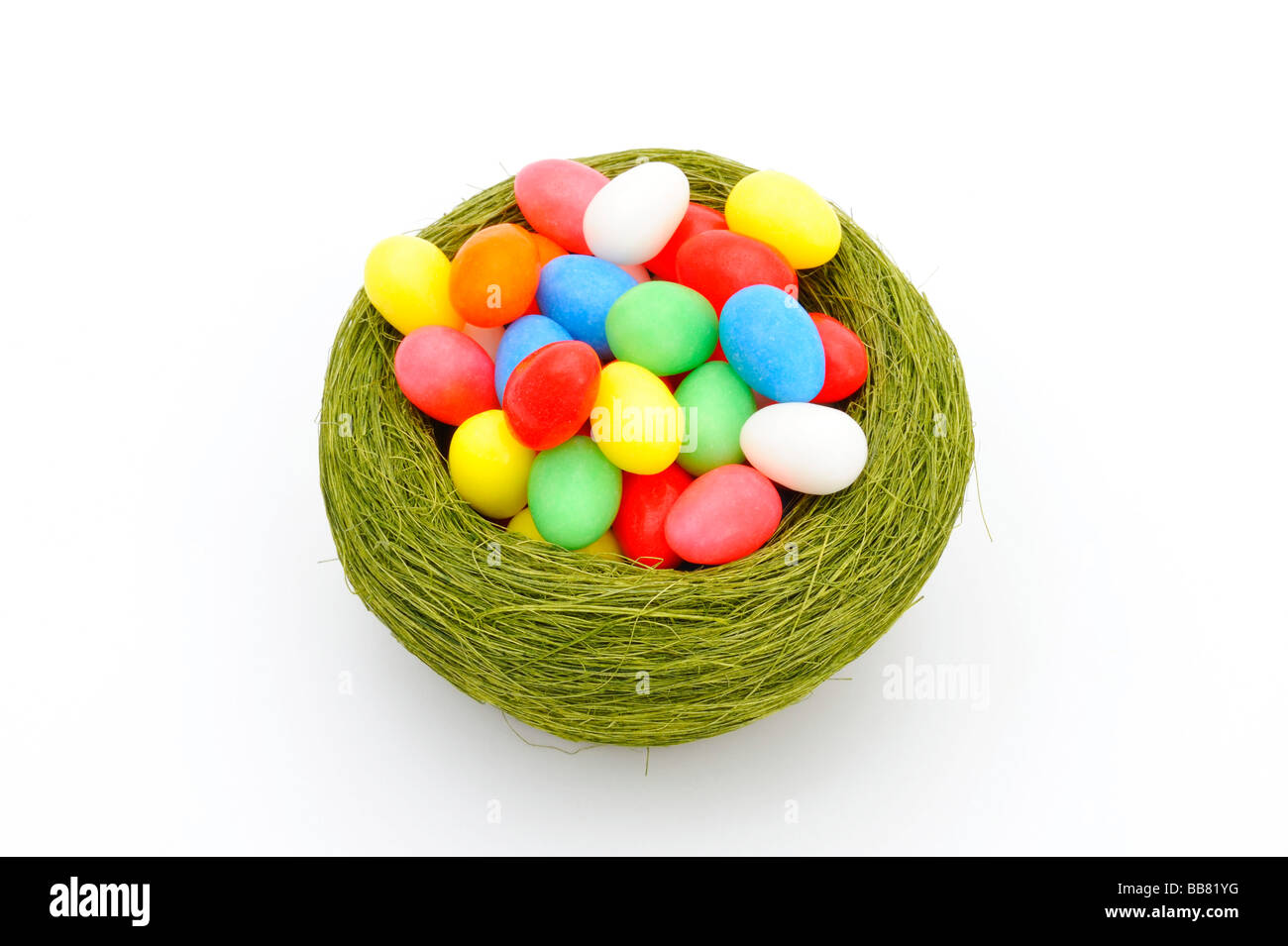 Candy easter eggs in an easter basket Stock Photo - Alamy
