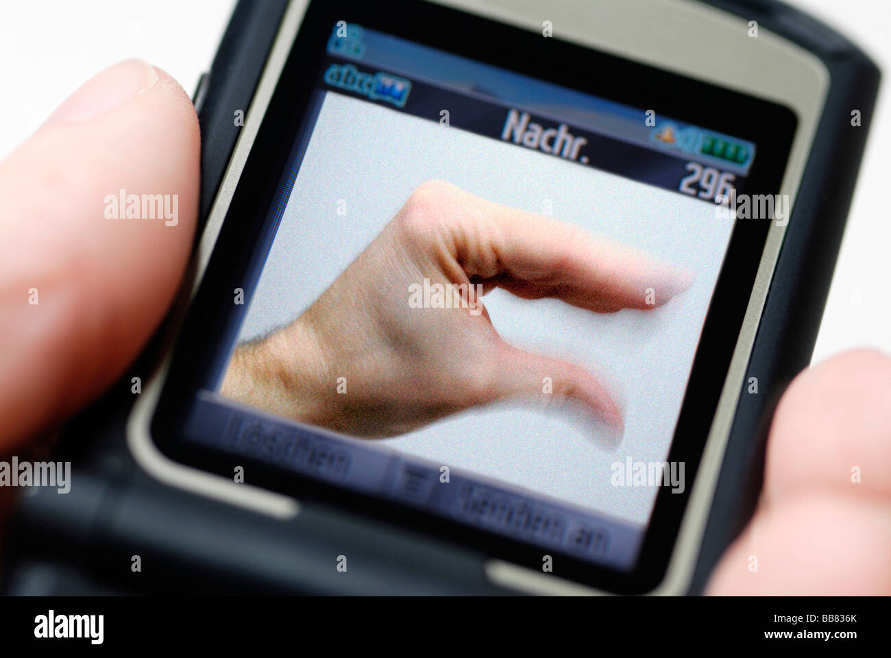 Mobile phone with a photo of a hand performing a blah-blah gesture ...