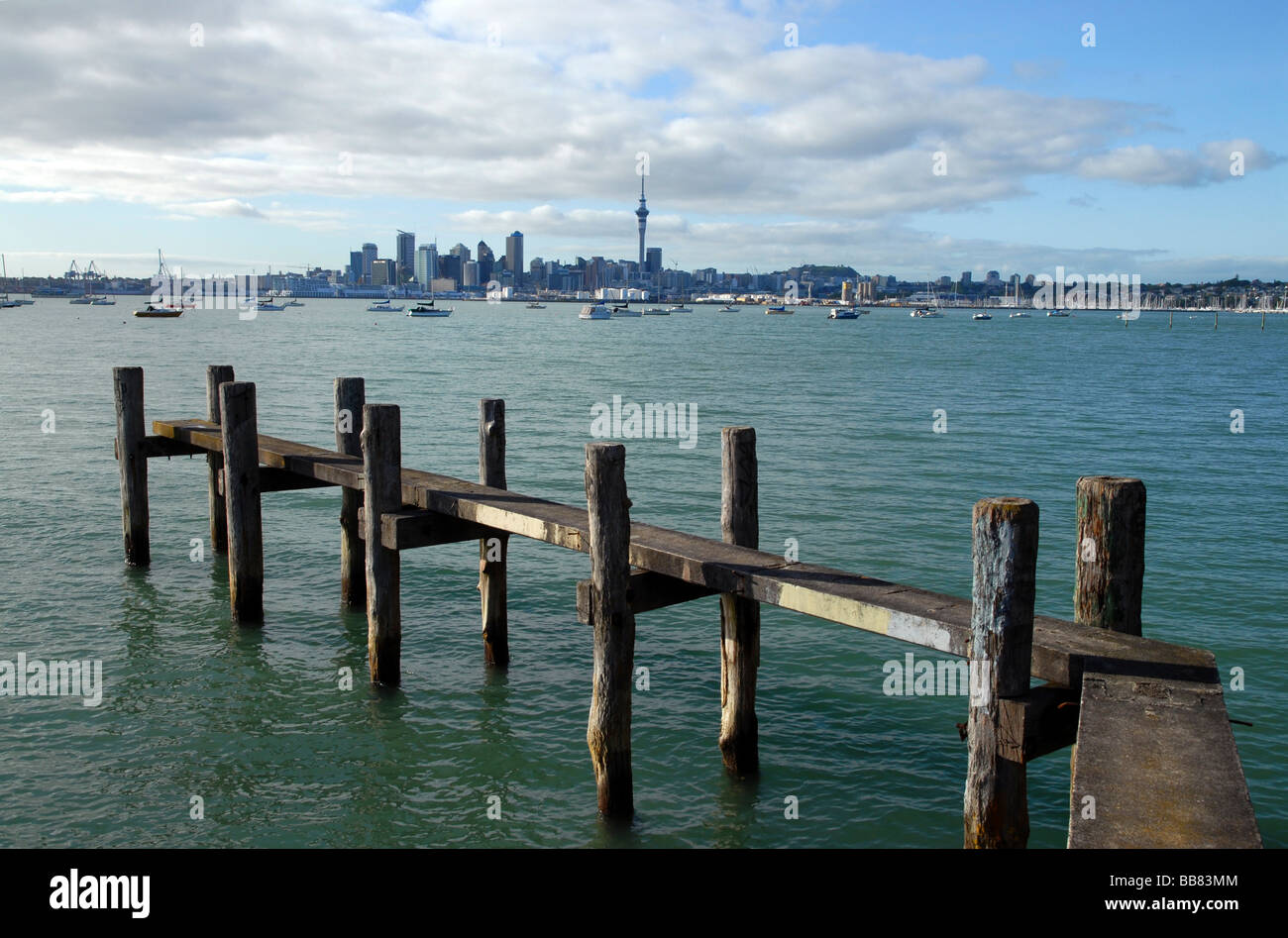 An old jetty in Northcote in front of the skyline of Auckland in the ...