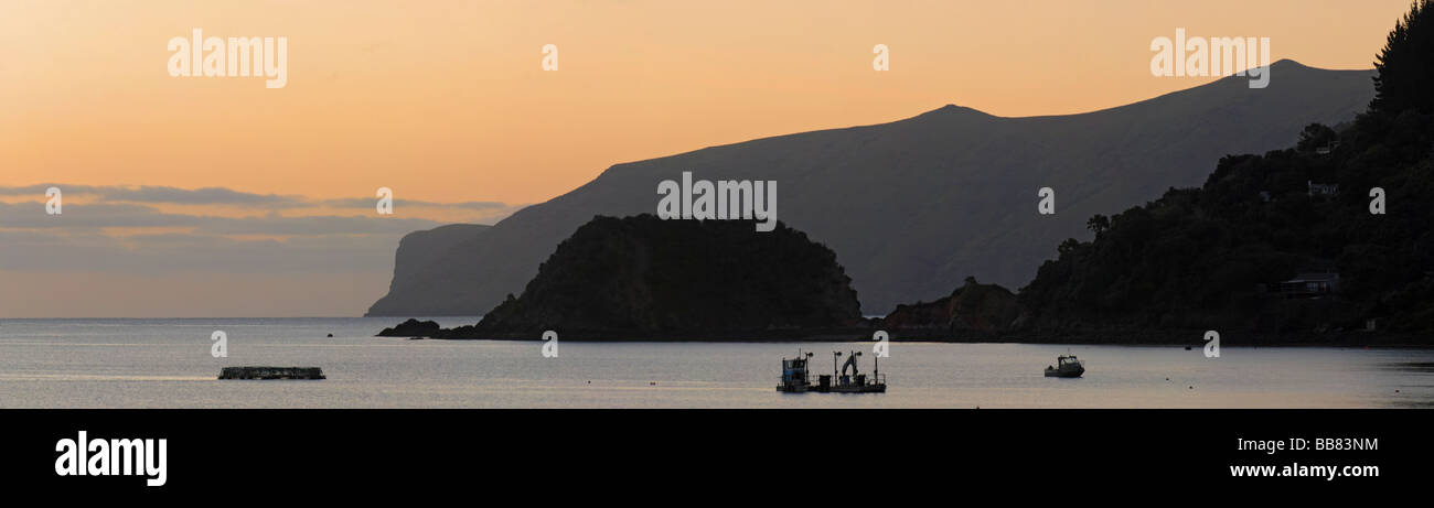 Sun rising over Akaroa Harbor at Banks Peninsula, seen from Wainui, New ...