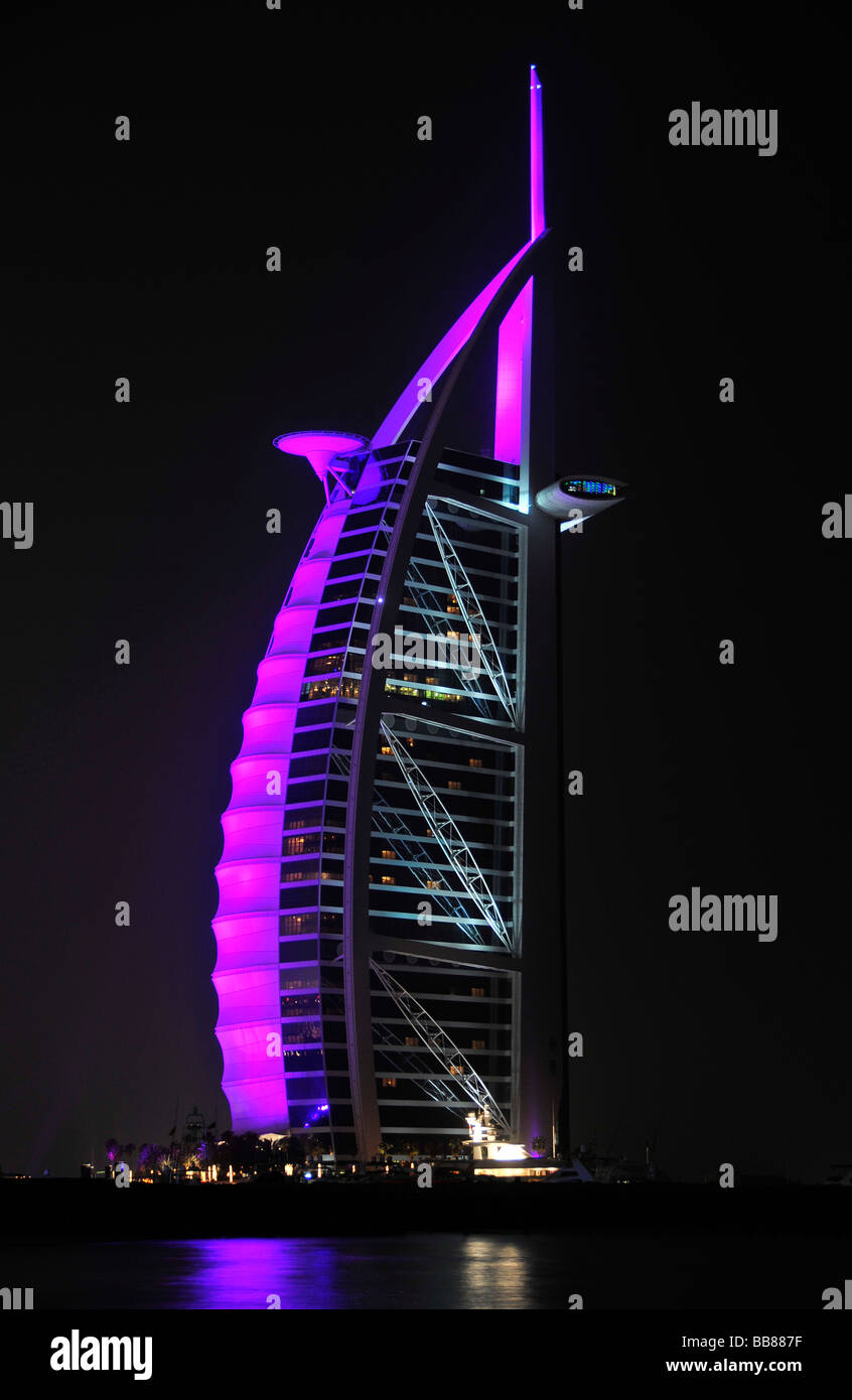 Illuminated facade of the seven-star hotel Burj al Arab at night ...