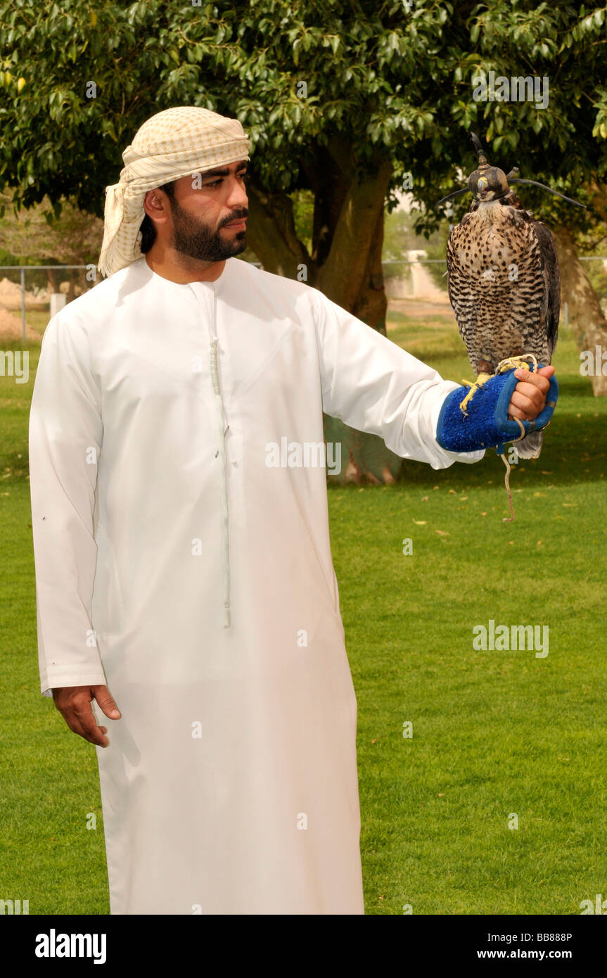 Falconer holding a falcon, the national animal of Abu Dhabi, at the Al ...