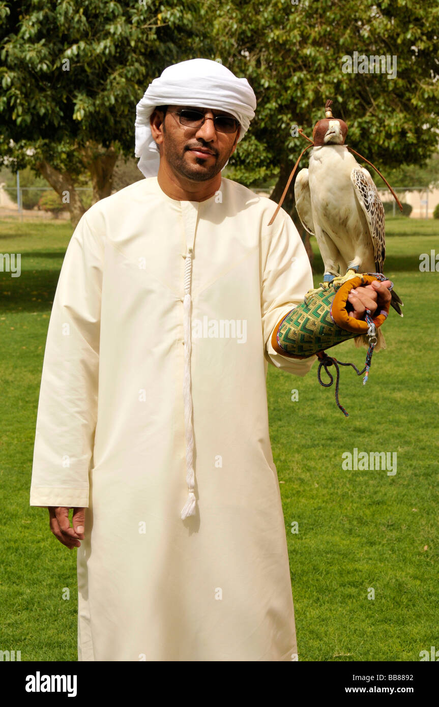 Falconer holding a falcon, the national animal of Abu Dhabi, at the Al ...